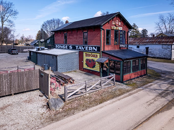 The weathered red exterior of Bonge's Tavern stands proudly in rural Perkinsville, where culinary pilgrims gather for hours before the doors even open.
