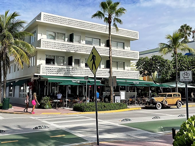 The iconic white Art Deco facade of News Cafe stands proudly on Ocean Drive, where Miami Beach's past and present mingle over coffee and conversation.