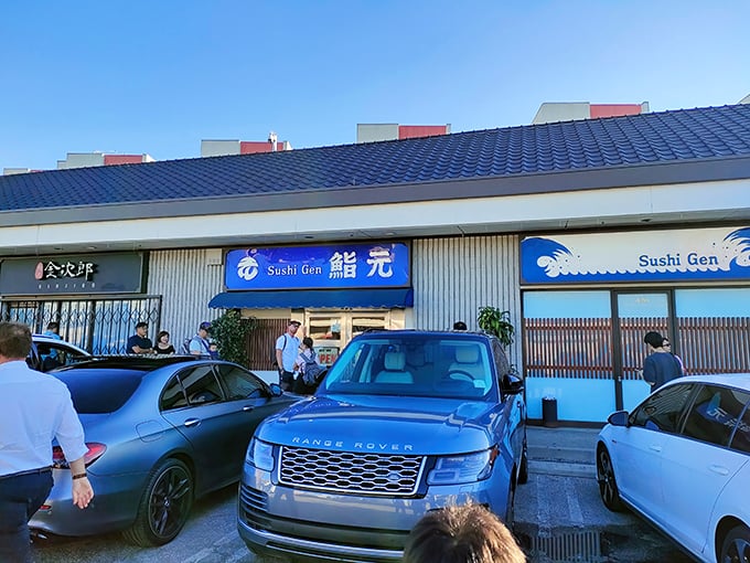 The blue-roofed storefront of Sushi Gen stands unassumingly in Little Tokyo, while the parking lot tells another story—luxury cars lined up for lunch like Hollywood's best-kept secret.