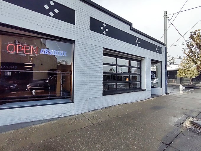 The unassuming white brick exterior of Shakabrah, with its garage-door windows and neon "OPEN" sign, belies the breakfast magic happening inside.