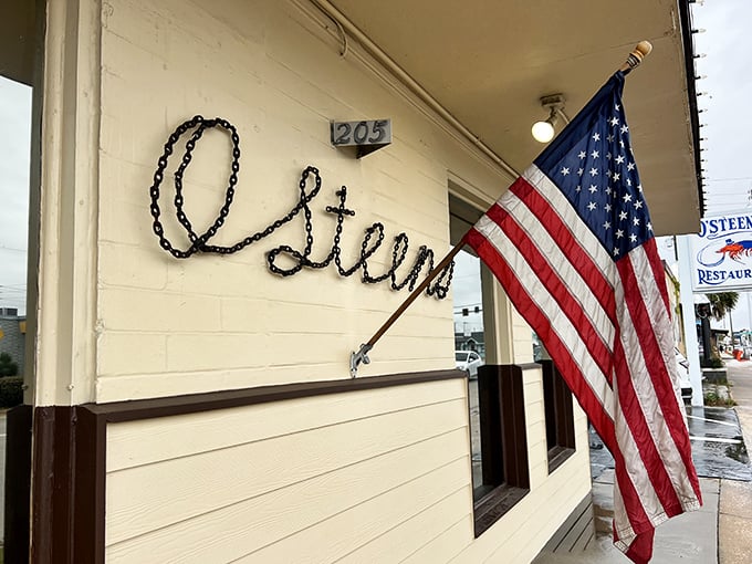 The unassuming exterior of O'Steen's, where that American flag isn't just patriotic decor—it's waving you in for seafood that'll make you salute.