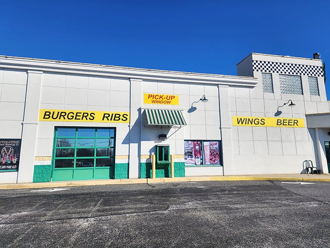 The white exterior boldly announces its priorities: BURGERS, RIBS, WINGS, BEER. No false advertising here—just a promise of delicious things to come.