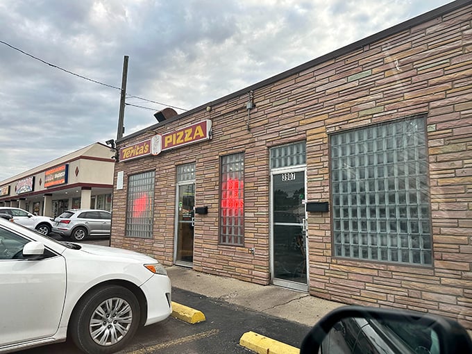 The unassuming stone facade of Terita's Pizza stands like a time capsule on Cleveland Avenue, promising pizza perfection behind those glass-block windows.