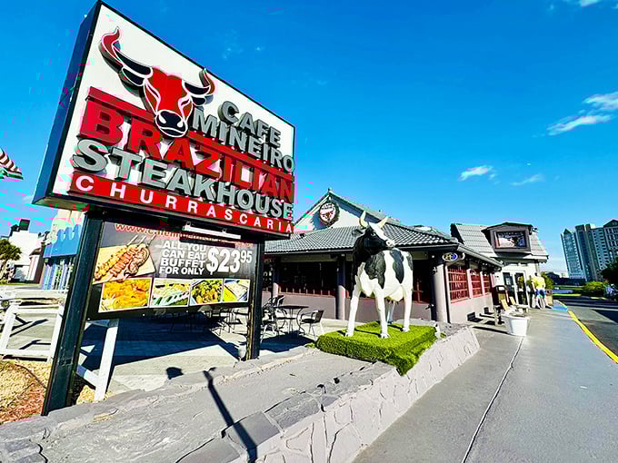 The iconic red bull logo welcomes hungry visitors to Cafe Mineiro, where that life-sized cow statue isn't just decoration—it's foreshadowing for the meat feast awaiting inside.