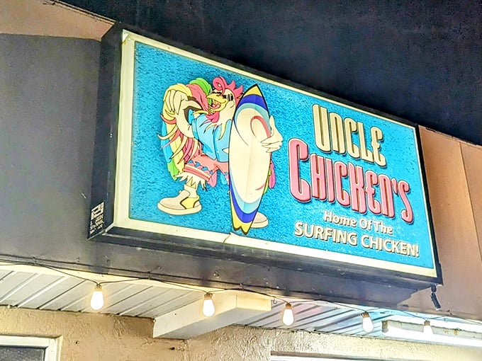 The surfing chicken beckons from this vibrant blue sign – a promise of coastal flavor that's about to change your fried chicken expectations forever.