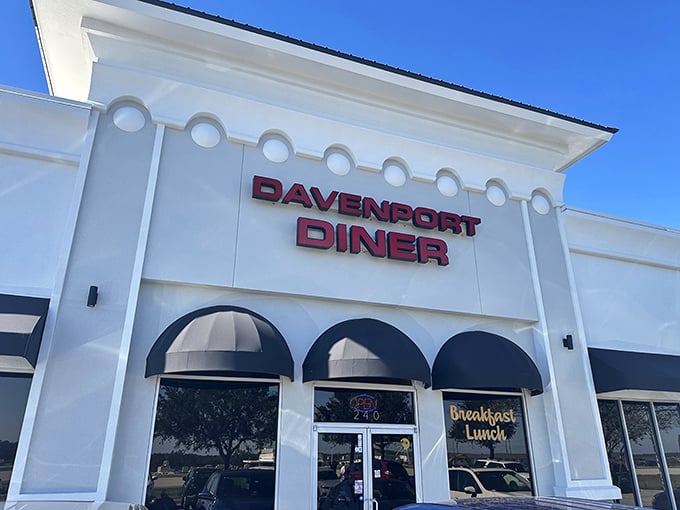 The bold red lettering against crisp white walls isn't just signage—it's a breakfast beacon calling to hungry souls across Davenport like a carb-loaded lighthouse.