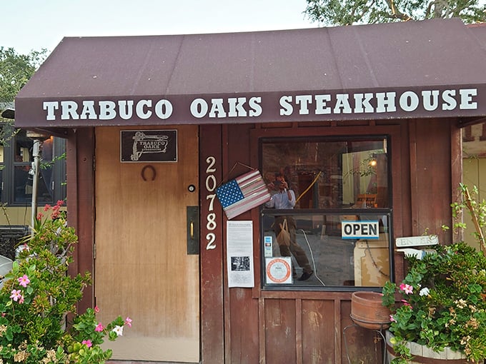 The rustic charm of Trabuco Oaks Steakhouse greets you at the entrance, offering a warm welcome that feels as genuine as the meal waiting inside.