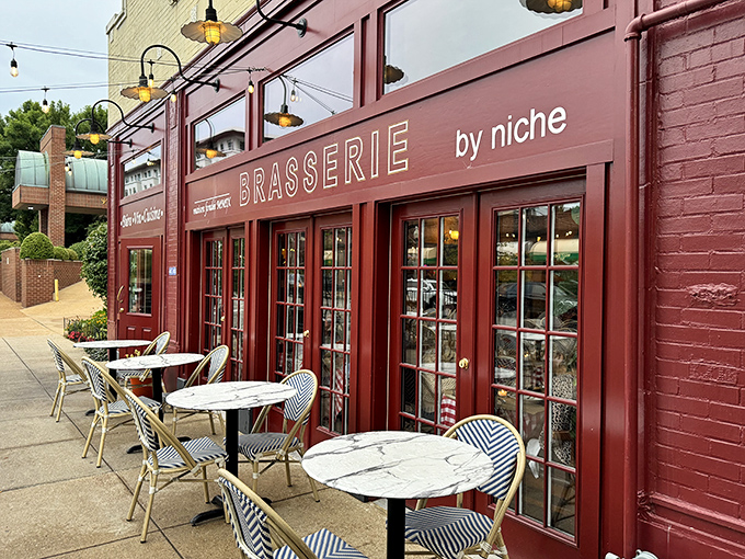 The burgundy facade of Brasserie by Niche beckons like a Parisian postcard come to life, complete with those blue-striped bistro chairs that practically whisper "sit here and stay awhile."