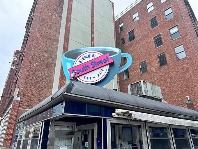 That iconic neon coffee cup sign isn't just advertising – it's a beacon of hope for hungry night owls across Boston's Leather District.