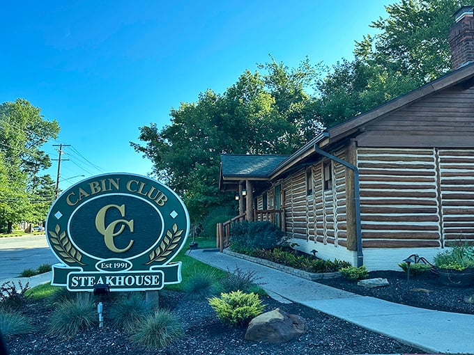 The Cabin Club's rustic log exterior stands like a woodland mirage on Westlake's Detroit Road, promising culinary adventures within its timber walls.