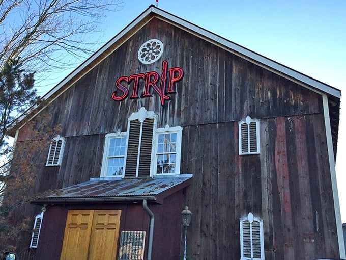 That iconic red neon sign against weathered wood is like a lighthouse for hungry travelers—guiding you to a harbor of exceptional steaks.