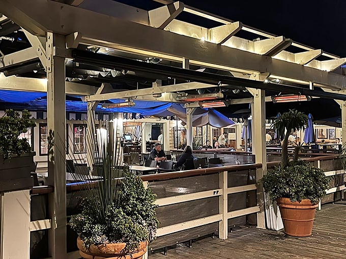 Sunset dining on the deck—where ocean breezes enhance every bite. The pergola-covered patio creates the perfect California evening atmosphere for seafood indulgence.