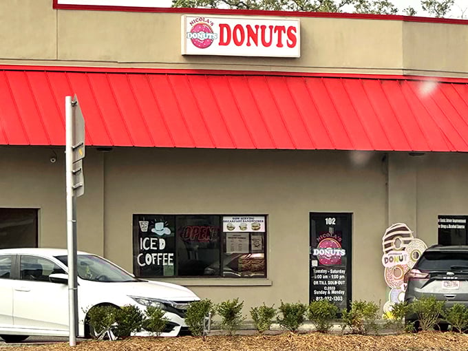 The unassuming storefront with its bright red awning is like a secret handshake among Tampa donut aficionados – you either know or you don't.