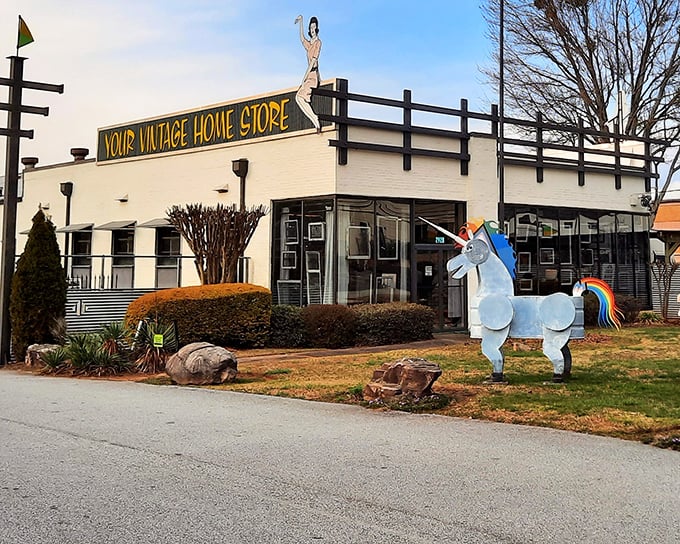 A unicorn standing guard outside Kudzu's white facade isn't just whimsical decor—it's your first clue that ordinary antique shopping has left the building.