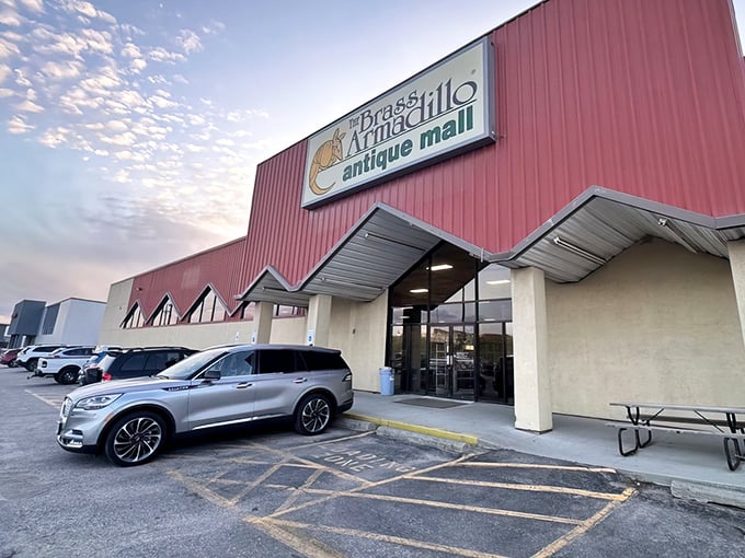 The iconic red exterior of Brass Armadillo welcomes treasure hunters with its distinctive armadillo logo—Nebraska's portal to the past.