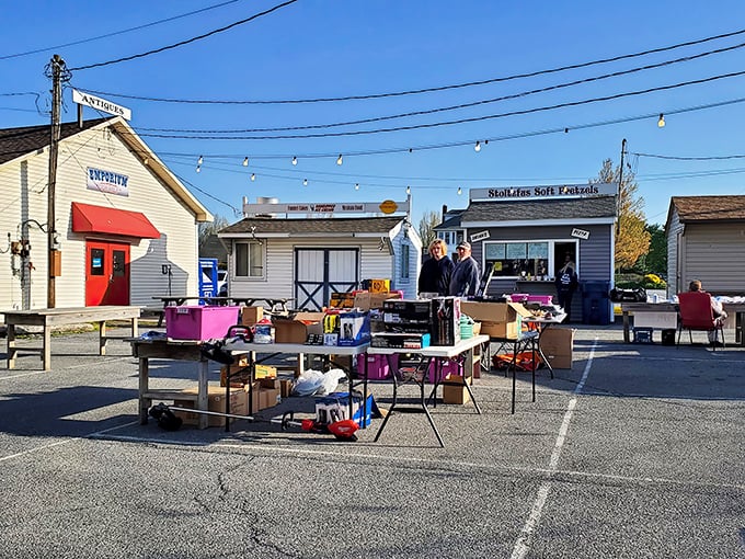 Treasure hunting begins here! Outdoor tables laden with potential finds await under the watchful eye of Root's charming storefronts.