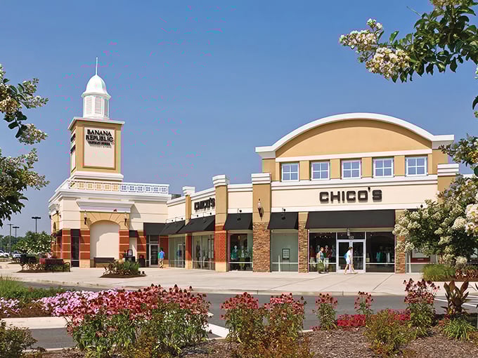 The iconic white cupola of Queenstown Premium Outlets stands like a retail lighthouse, beckoning shoppers to safe harbor—where wallets may not be so safe.