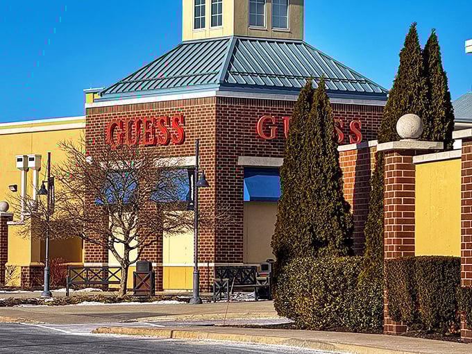 The iconic GUESS storefront stands like a fashion beacon, its red lettering promising designer styles without the designer price tags.