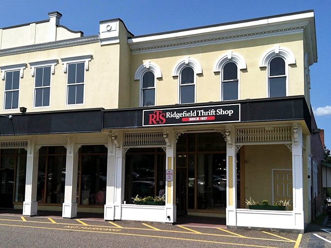 The historic façade of Ridgefield Thrift Shop stands proudly on Main Street, its cream-colored walls and arched windows promising treasures within.