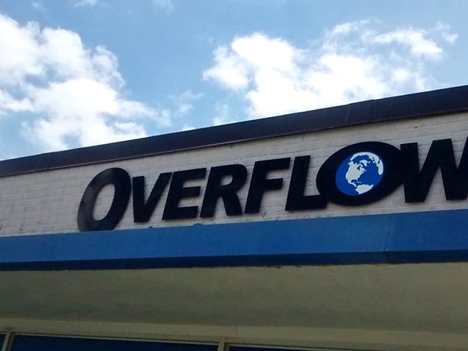 Overflow's iconic sign against the Iowa sky – where the globe logo hints at the world of possibilities waiting for intrepid treasure hunters within.