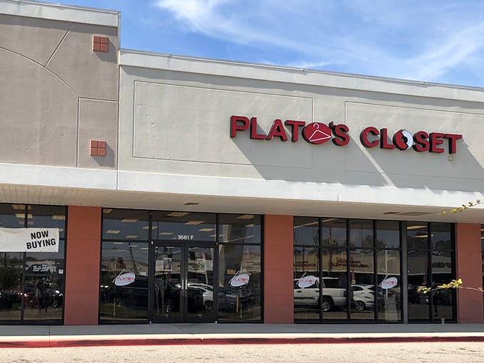 The iconic red signage of Plato's Closet stands out against the neutral facade, like a beacon for bargain hunters with designer dreams.