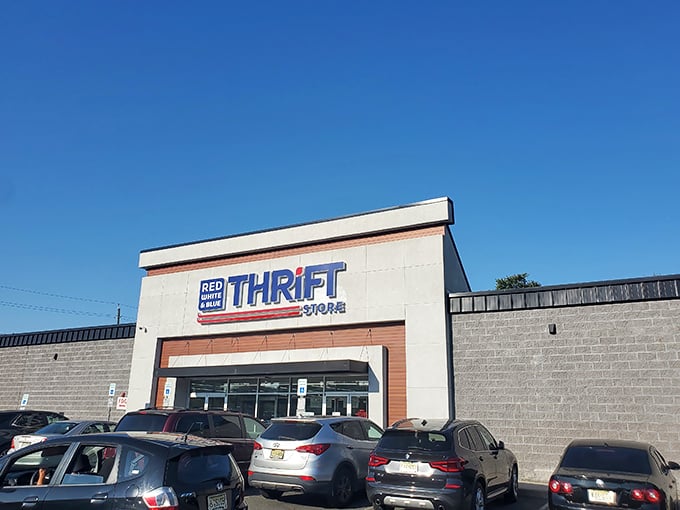 The unassuming facade of Red White & Blue Thrift Store – like finding a treasure chest disguised as an ordinary box, this patriotic portal promises adventures in secondhand splendor.