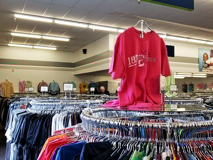 Racks upon racks of colorful clothing stretch into the distance, with a bright red t-shirt standing sentinel over this treasure hunter's paradise.
