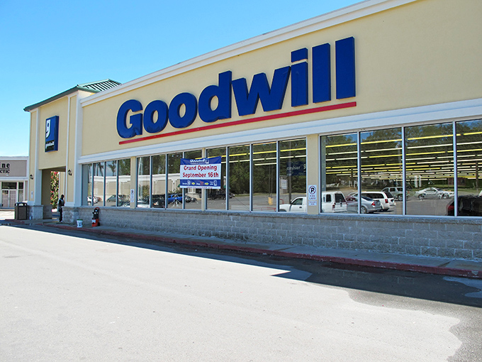 The blue Goodwill sign glows like a beacon of bargain-hunting hope against the Arkansas sky. Treasure awaits inside!