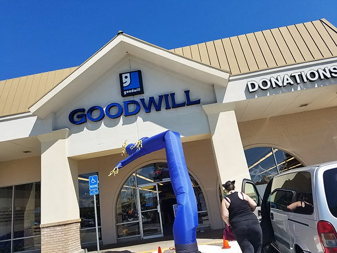 Sunny skies frame this thrifter's paradise, where one person's donations become another's fashion statement – all under that iconic blue "g" logo.