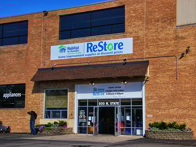 The unassuming brick exterior of ReStore hides a treasure trove within—like finding out your quiet neighbor collects vintage Ferraris in the garage.