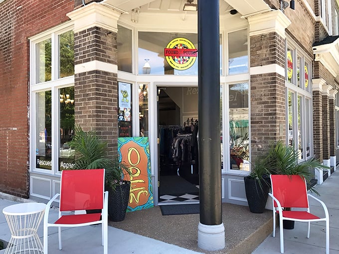 The inviting storefront of Found Vintage beckons with its classic brick architecture and those cherry-red chairs that practically whisper, "Come sit, then shop!"