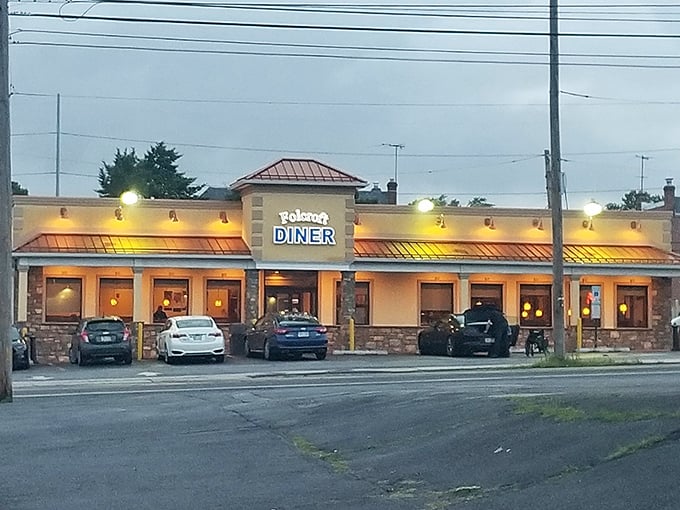 The warm glow of Folcroft Diner at dusk beckons like an old friend saying, "Come on in, I saved you a seat."
