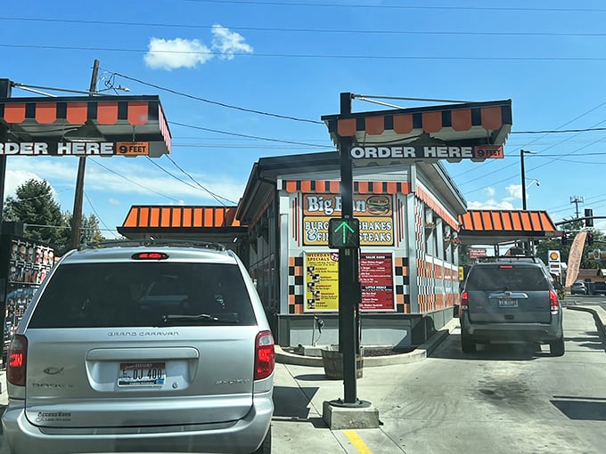 Classic drive-in culture lives on at Big Bun, where the orange-striped awnings and "ORDER HERE" signs promise a delicious trip back to simpler times.