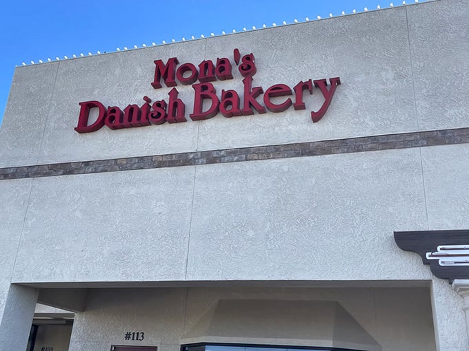 The bold red lettering against the cream-colored exterior isn't just signage—it's a beacon of hope for carb enthusiasts seeking Danish delights in the Arizona desert.