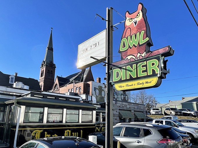 The iconic Owl Diner sign stands proudly against the Lowell skyline, promising comfort food salvation to hungry Massachusetts souls.