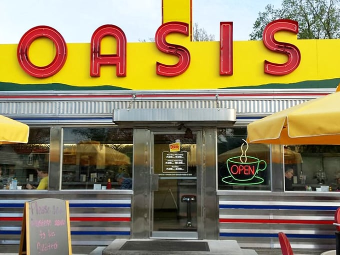 The neon glow of that "OPEN" sign might as well say "HAPPINESS SERVED HERE"—a portal to simpler times when coffee was endless and conversation flowed freely.