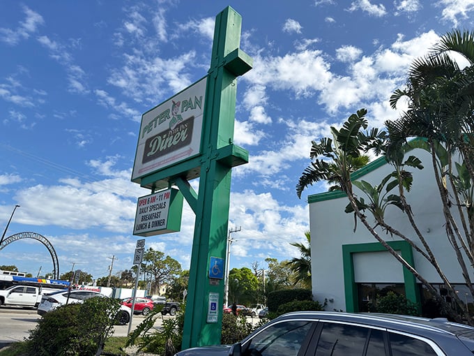The neon glow of Peter Pan Diner against the Florida night sky isn't just inviting—it's practically a beacon for breakfast lovers seeking refuge from trendy avocado toast establishments.