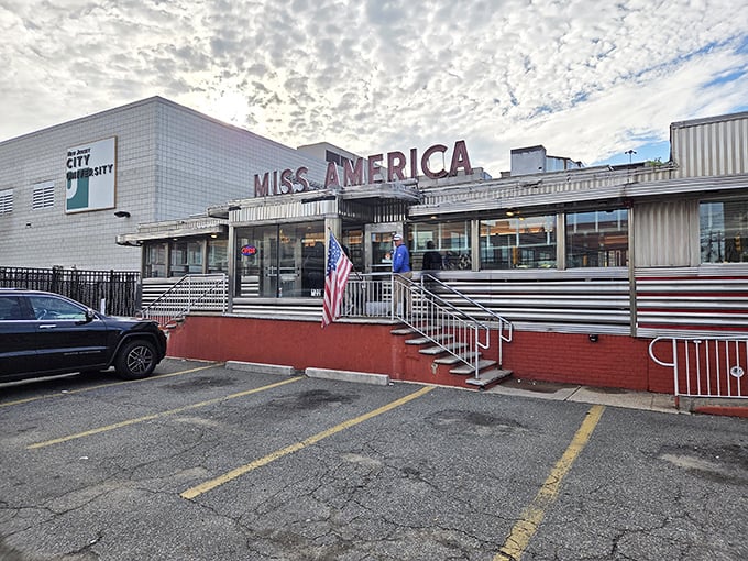 The classic stainless steel exterior of Miss America Diner gleams under Jersey City skies, a time capsule of American dining culture waiting to welcome hungry visitors.