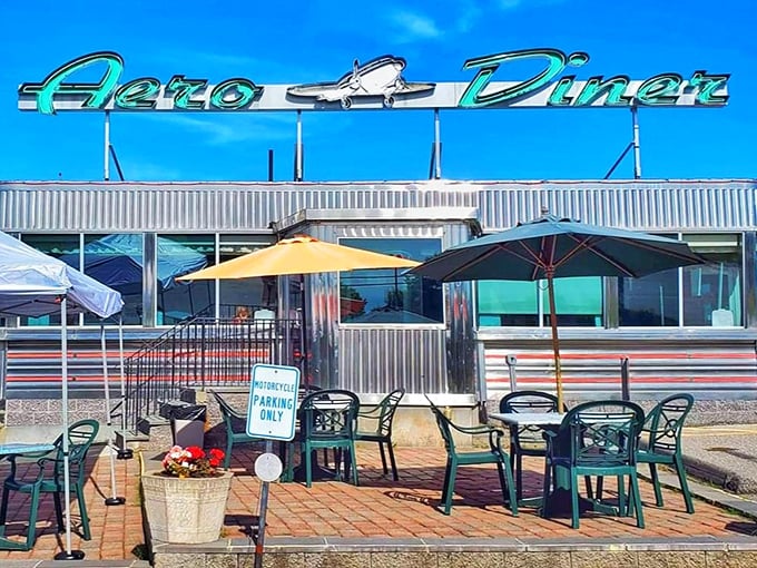 The gleaming turquoise sign against Connecticut's blue sky promises breakfast nirvana. This isn't just a diner—it's a stainless steel time machine serving morning magic.