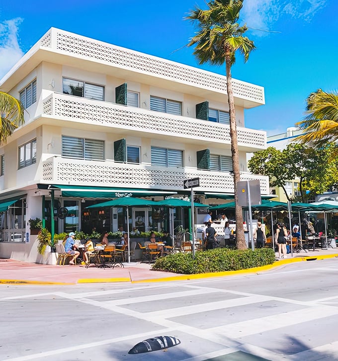 The iconic white Art Deco façade of News Cafe stands proudly on Ocean Drive, where Miami's vibrant energy meets European café culture.