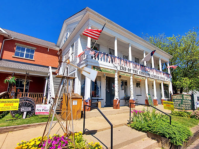 The white clapboard façade of End of the Commons General Store stands proudly against a blue Ohio sky, American flags fluttering like a welcome committee.