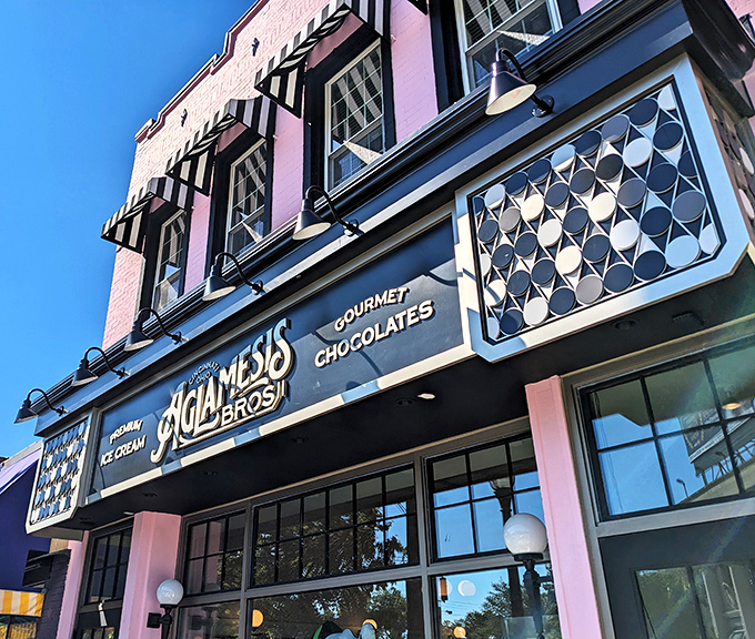 The pink palace of Oakley beckons with its vintage charm. Aglamesis Bros' distinctive façade promises sweet treasures within, standing proudly against the Cincinnati sky.