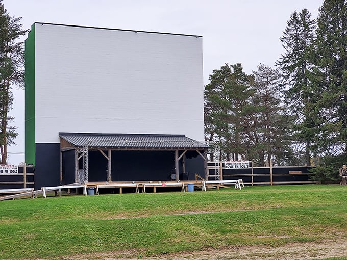 The massive white screen stands ready against Pennsylvania's evergreens, a blank canvas awaiting twilight's transformation into movie magic.
