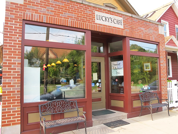 The unassuming brick façade of Lucky's Café hides culinary treasures within. Those benches aren't just for show—they're for the inevitable (and worthwhile) weekend wait.