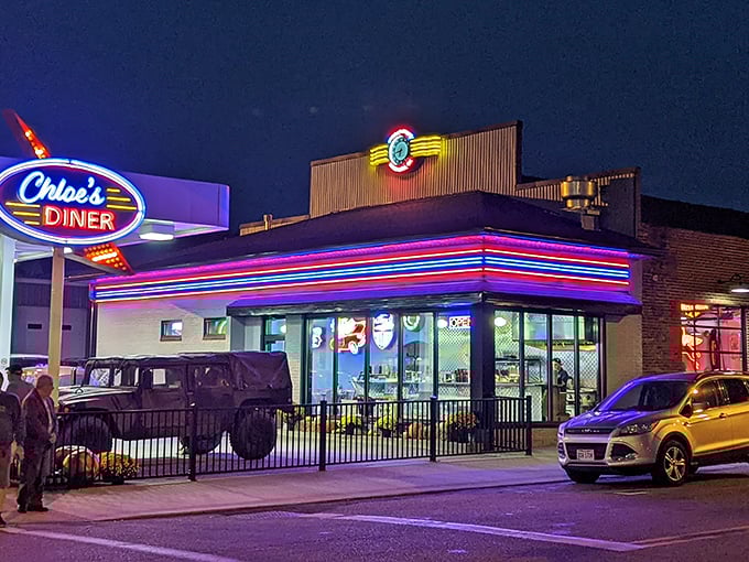 Neon dreams come alive at twilight as Chloe's Diner glows with electric promise, a beacon of comfort food that makes passing by without stopping nearly impossible.