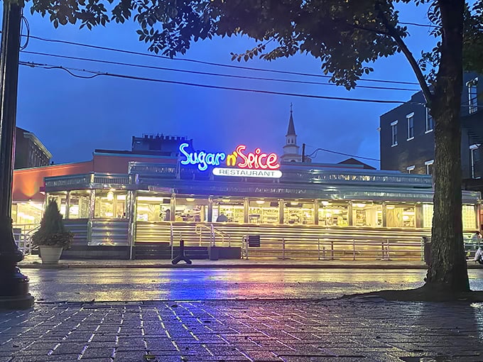 The neon glow of Sugar n' Spice at dusk is like a beacon for breakfast lovers—a pink-hued promise of fluffy omelets and morning magic awaiting inside.