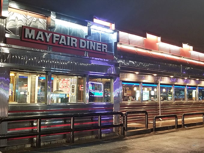 The neon glow of Mayfair Diner at night isn't just illumination—it's a beacon calling hungry Philadelphians home to comfort food paradise.