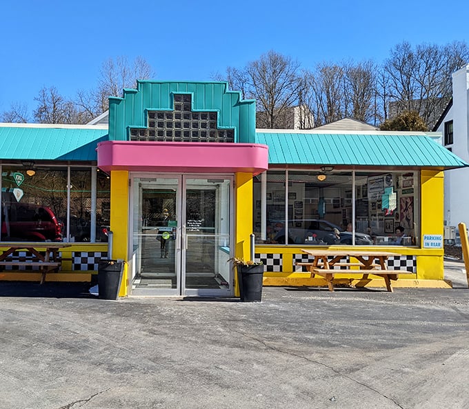 The turquoise, pink, and yellow exterior of Valliant's Diner looks like the 1950s and Miami Vice had a beautiful architectural baby.