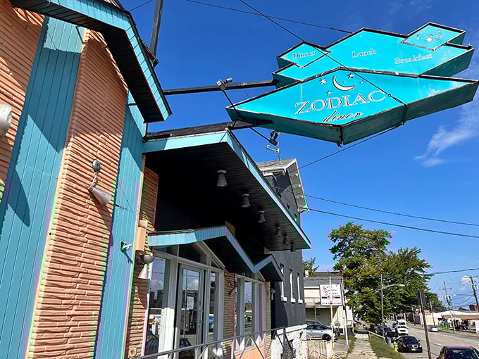 The iconic turquoise diamond sign of Zodiac Dinor beckons breakfast enthusiasts like a celestial lighthouse guiding hungry ships to harbor.
