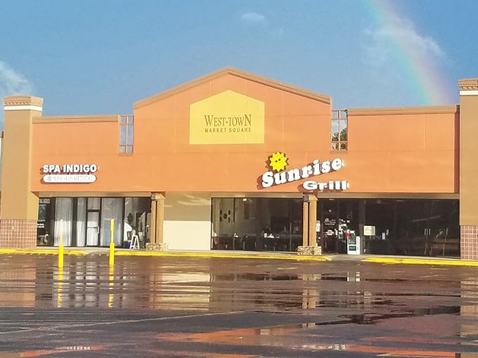 A rainbow arches over Sunrise Grill in Westtown Market Square – nature's own endorsement of Augusta's beloved breakfast haven.